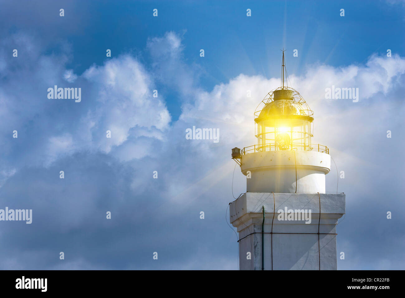 Lighthouse shining against blue sky Stock Photo - Alamy