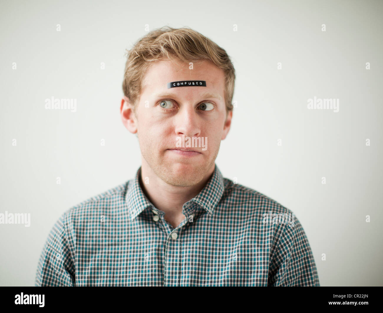 Studio shot of young man with black concept label on forehead Stock ...
