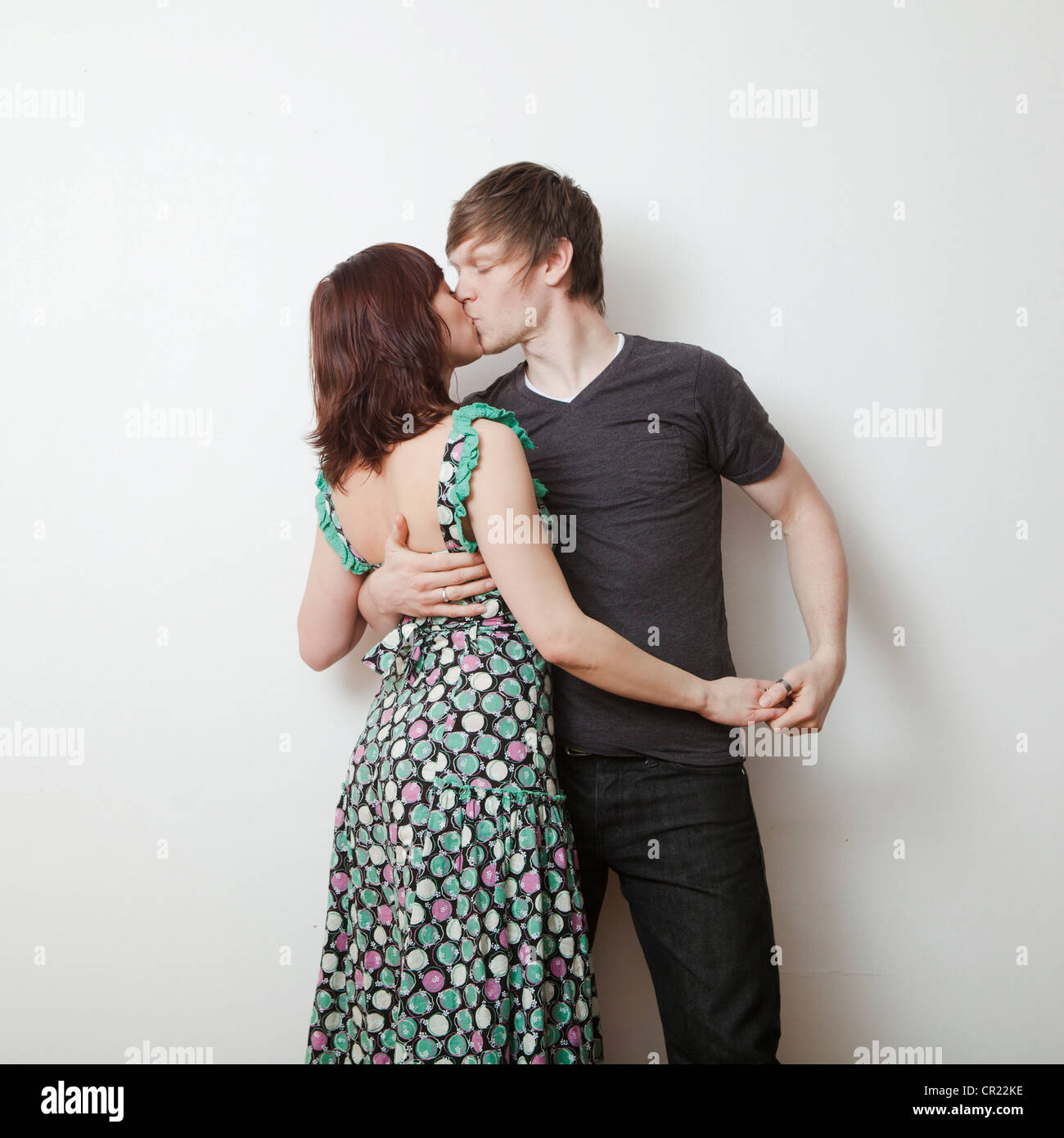 Happy young couple kissing in studio Stock Photo - Alamy