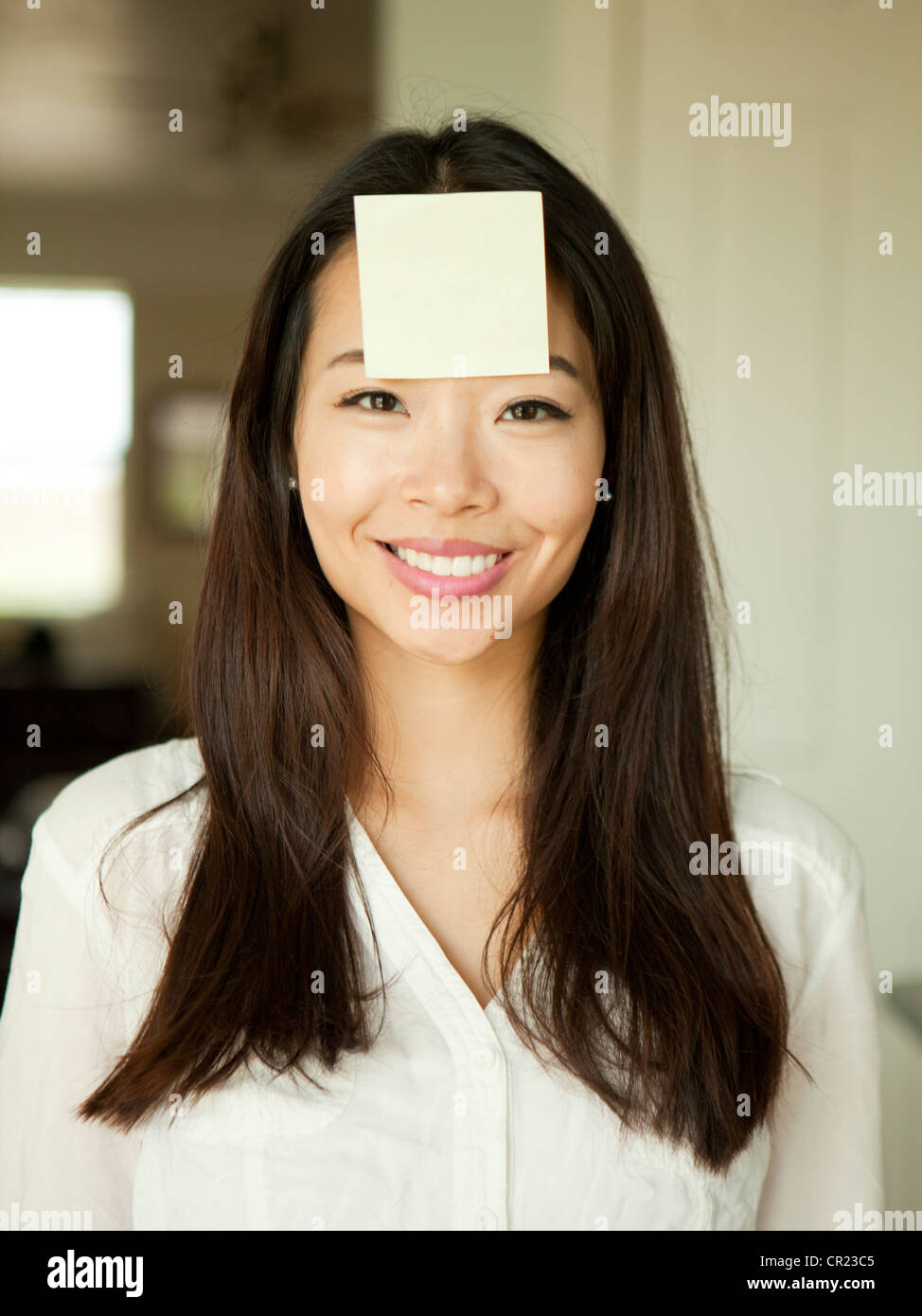 Portrait of young woman with adhesive note stuck to her forehead Stock ...