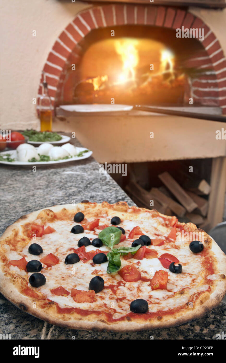 Pizza on counter in kitchen Stock Photo - Alamy