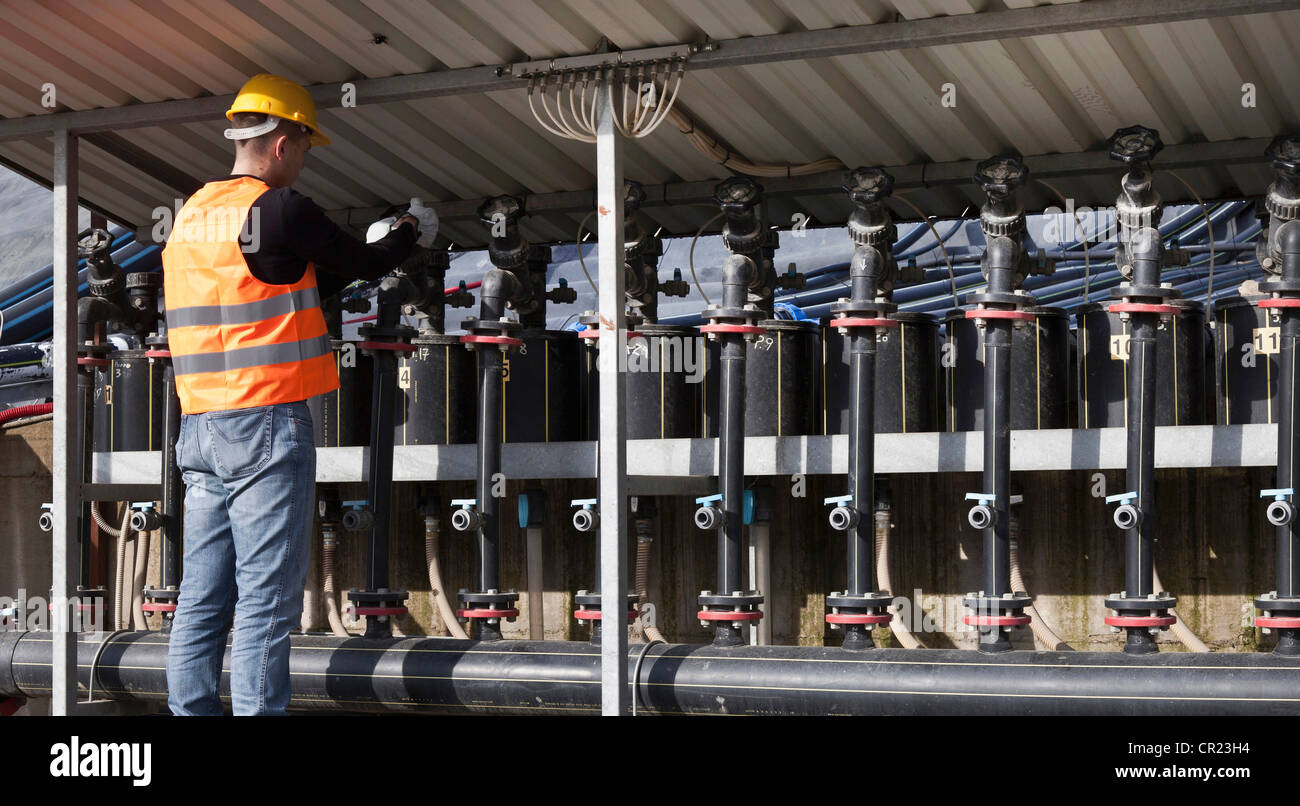 Worker at garbage collection center Stock Photo - Alamy