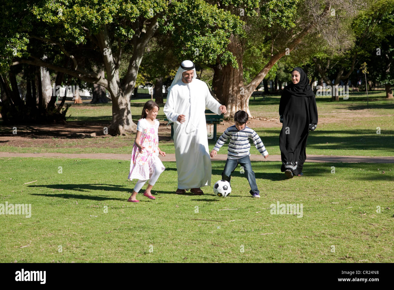 Arab family playing soccer together at the park Stock Photo - Alamy