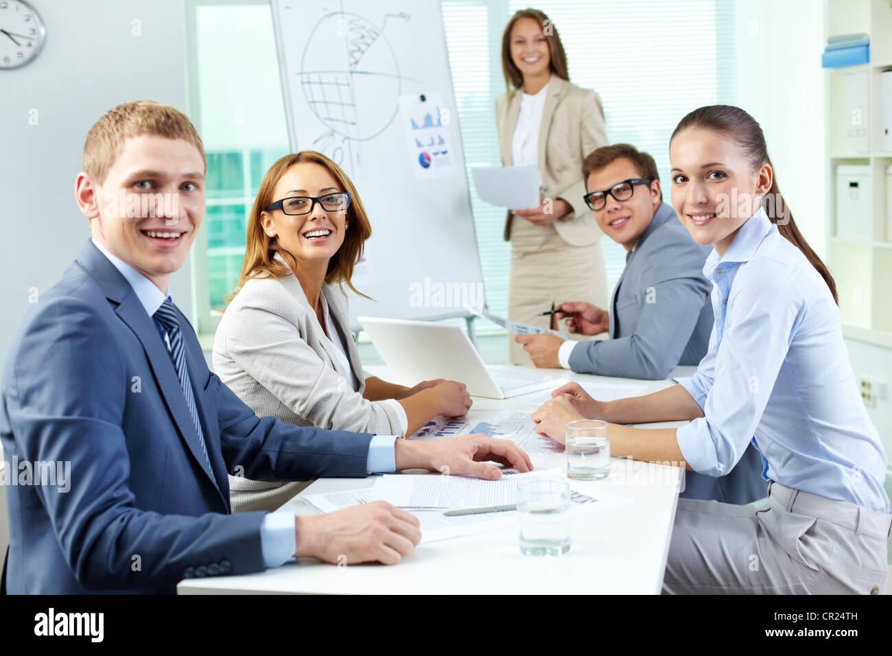 Cheerful team members looking at camera and smiling Stock Photo - Alamy