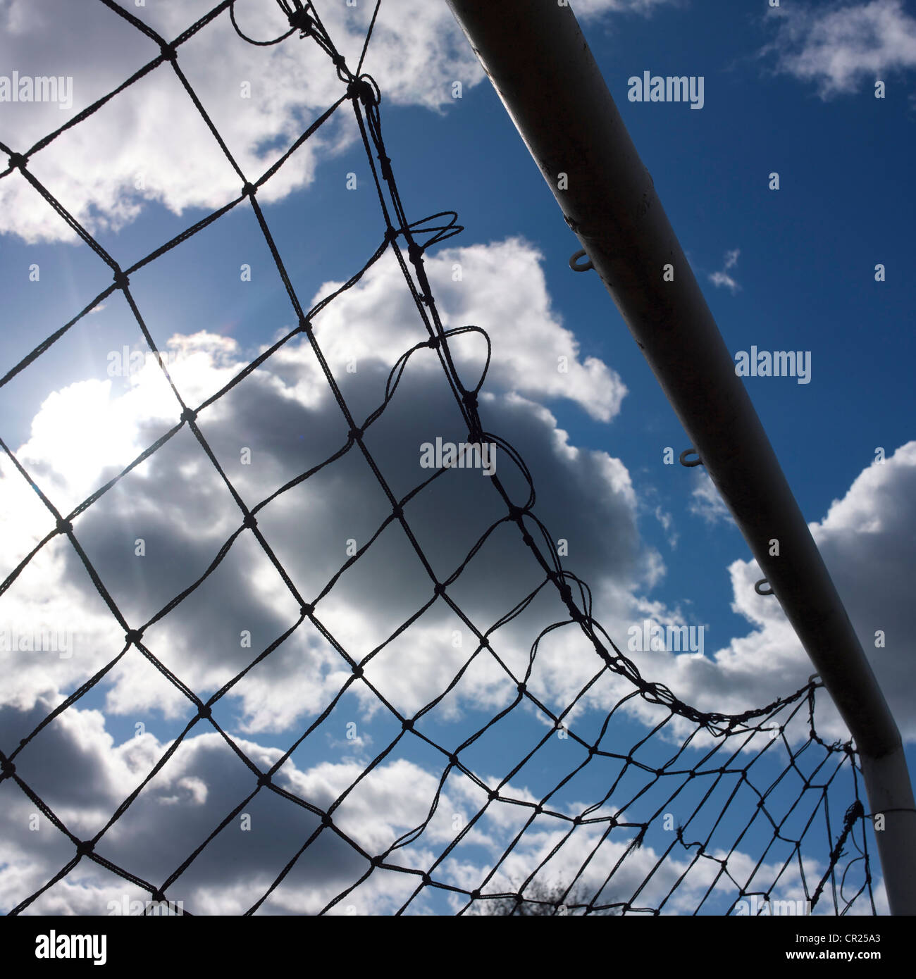 Net against a bright sky with clouds during a sunny day in a sports ...
