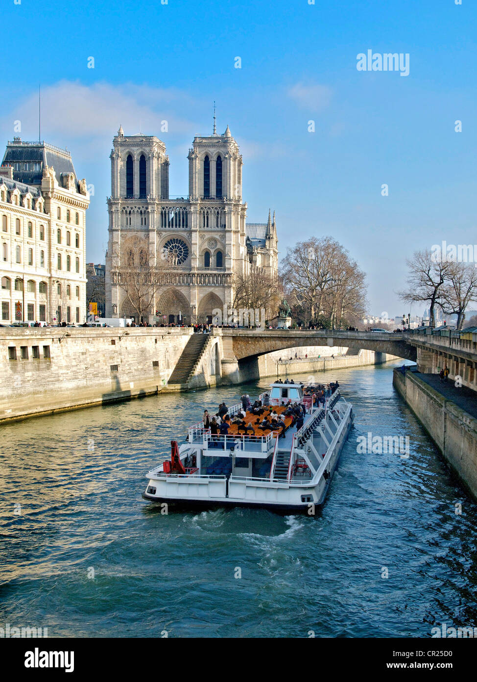 Notre Dame cathedral and pleasure cruise boat on the Seine river, Paris ...