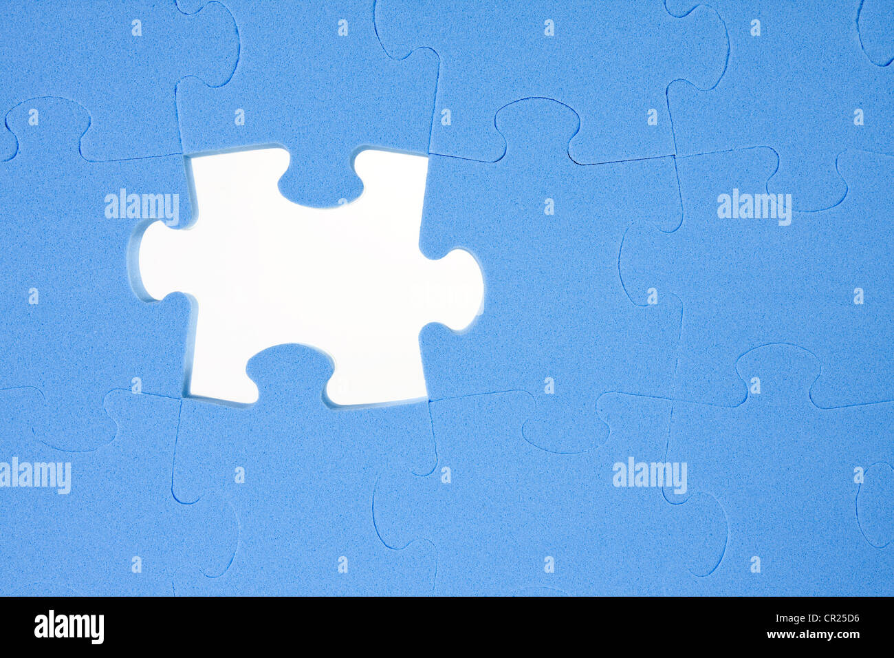one piece missing from blue jigsaw puzzle Stock Photo - Alamy