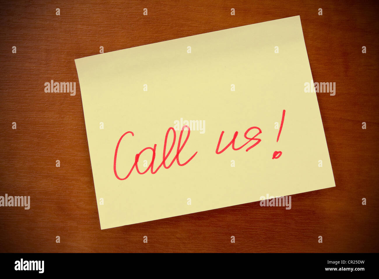 wooden board with yellow sticky note "call us Stock Photo - Alamy