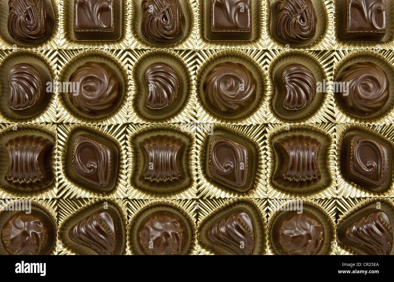 dark chocolate pralines in a golden box Stock Photo - Alamy