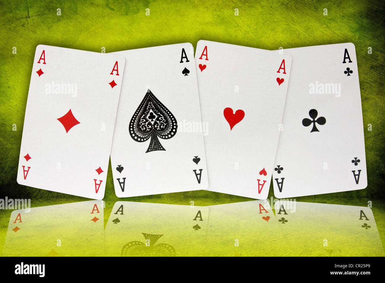 four aces with reflection on green background Stock Photo - Alamy