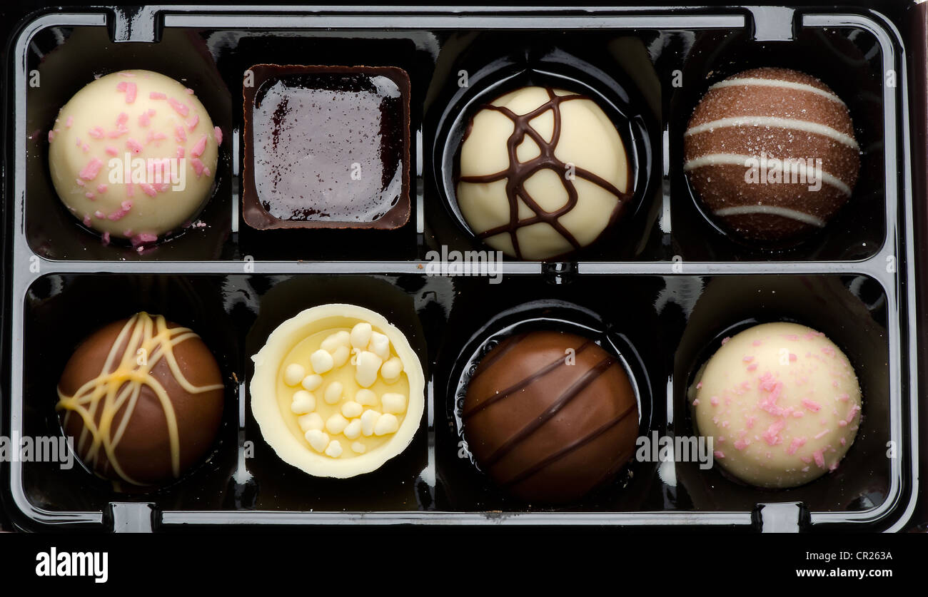 Close-up of a box of luxury chocolates shot in the studio with a white ...