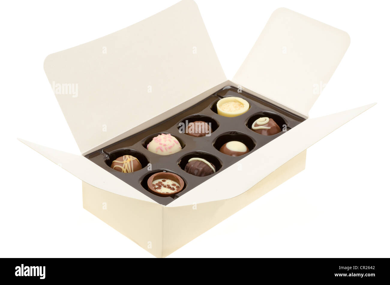 Opened box of luxury chocolates shot in the studio with a white ...