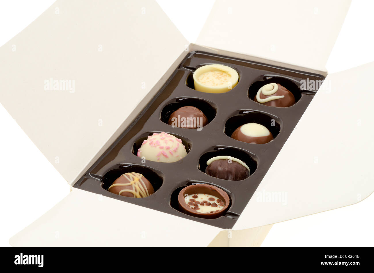 Opened box of luxury chocolates shot in the studio with a white ...