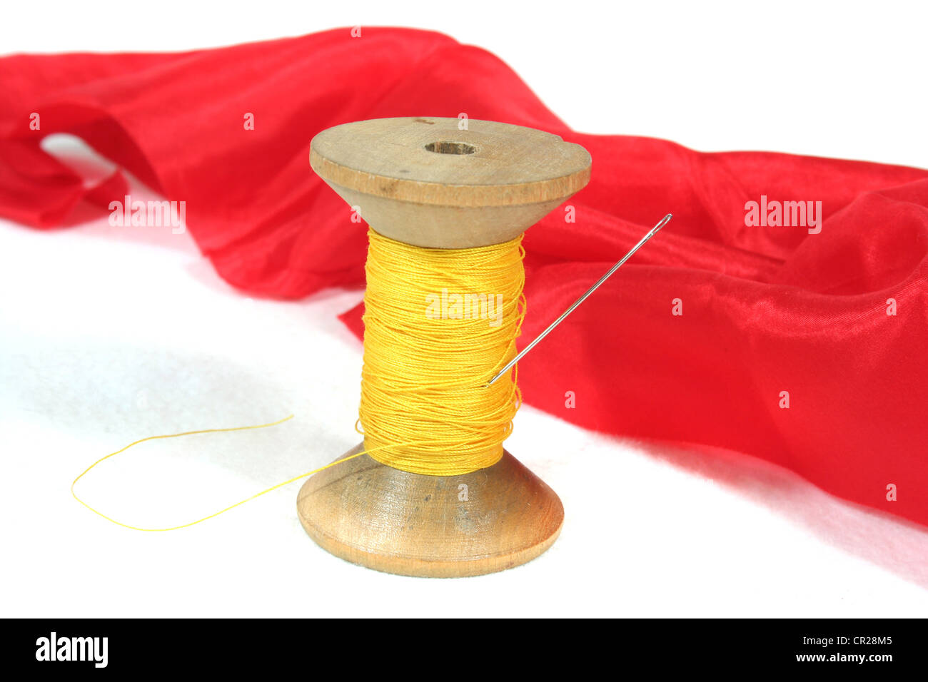 old spool of thread with needle and silk on a white background Stock ...