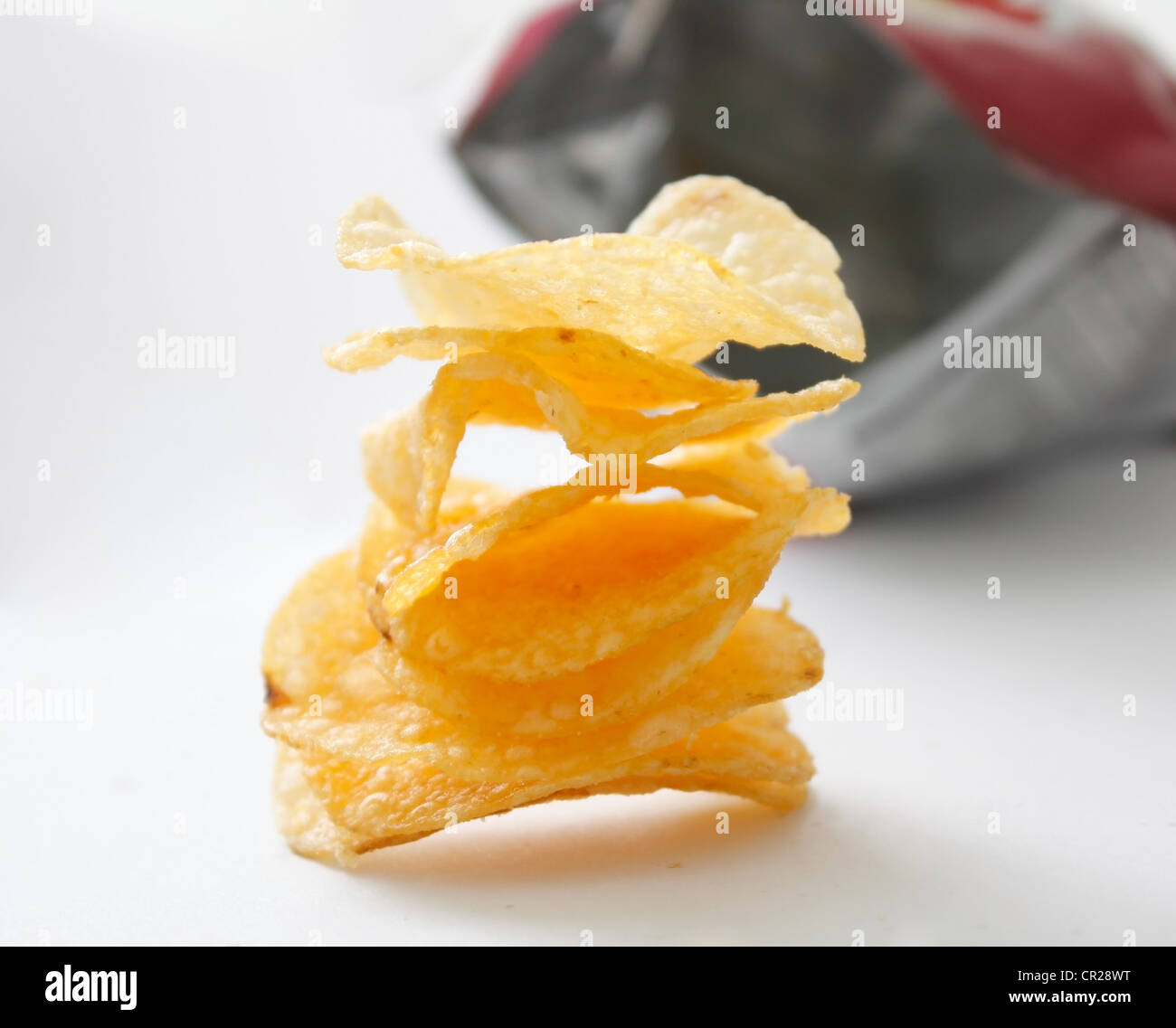 A stack of potato chips on white Stock Photo - Alamy