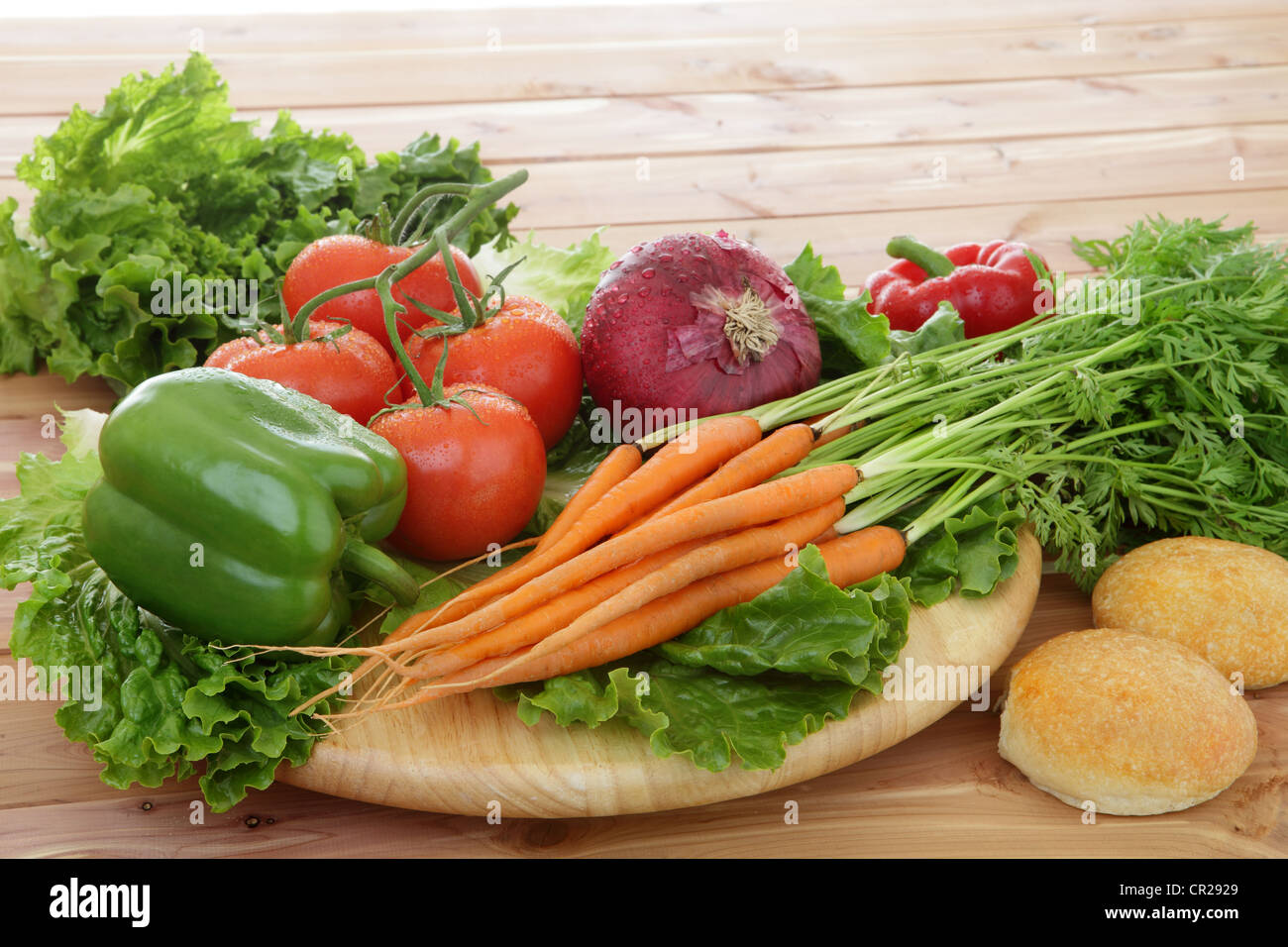 Organic vegetables in rustic setting including tomatoes on the vine ...