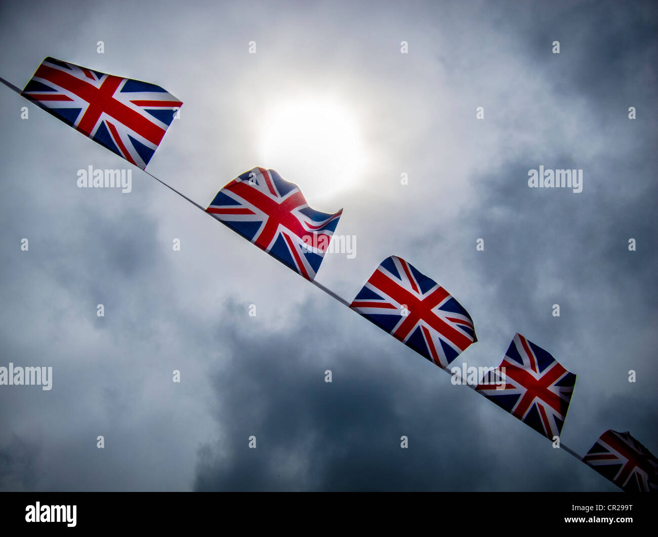A row of Union Jack Flags flying against a storm cloud sky Stock Photo ...