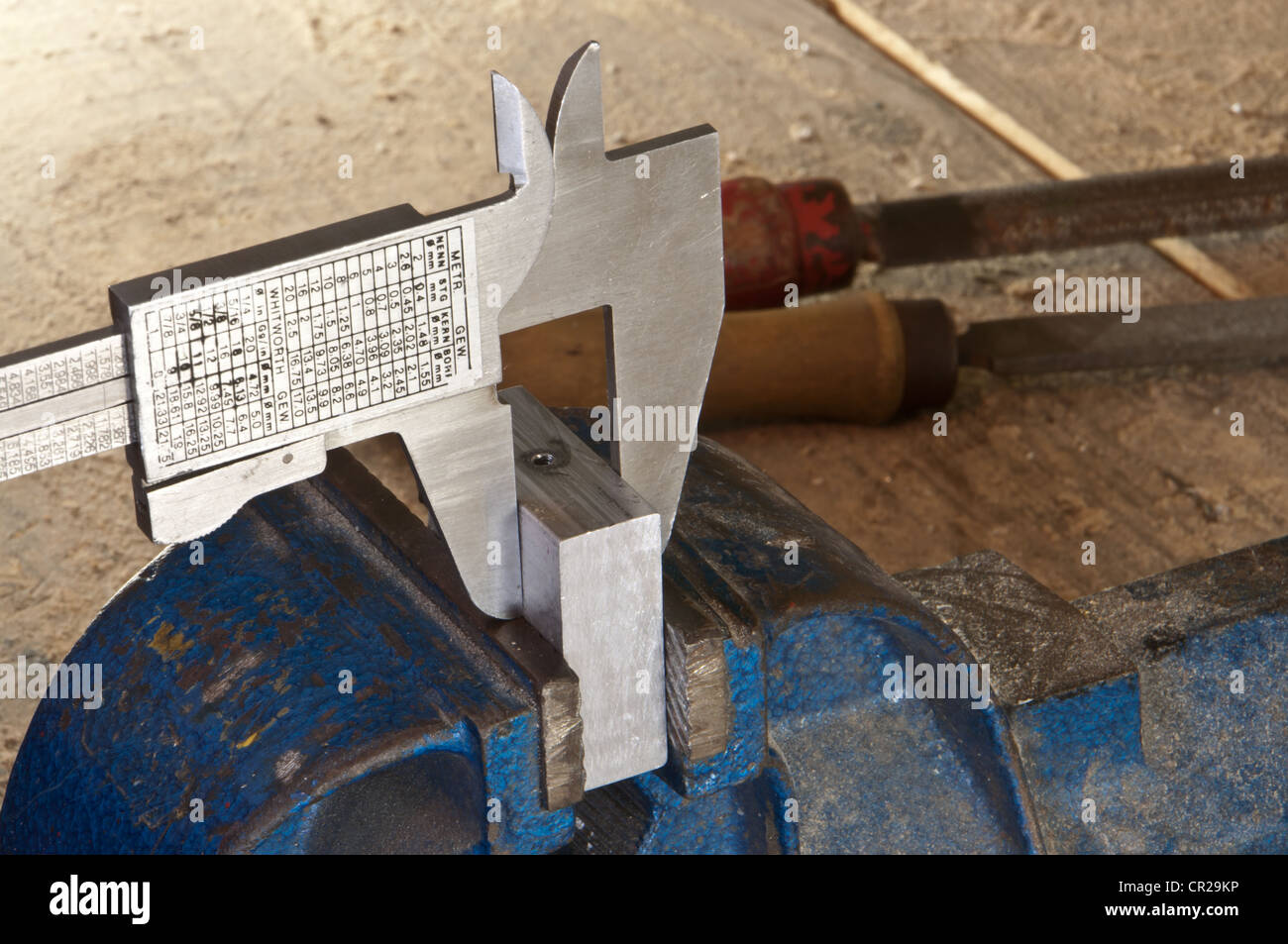 Measuring a block of metal with a caliper Stock Photo - Alamy