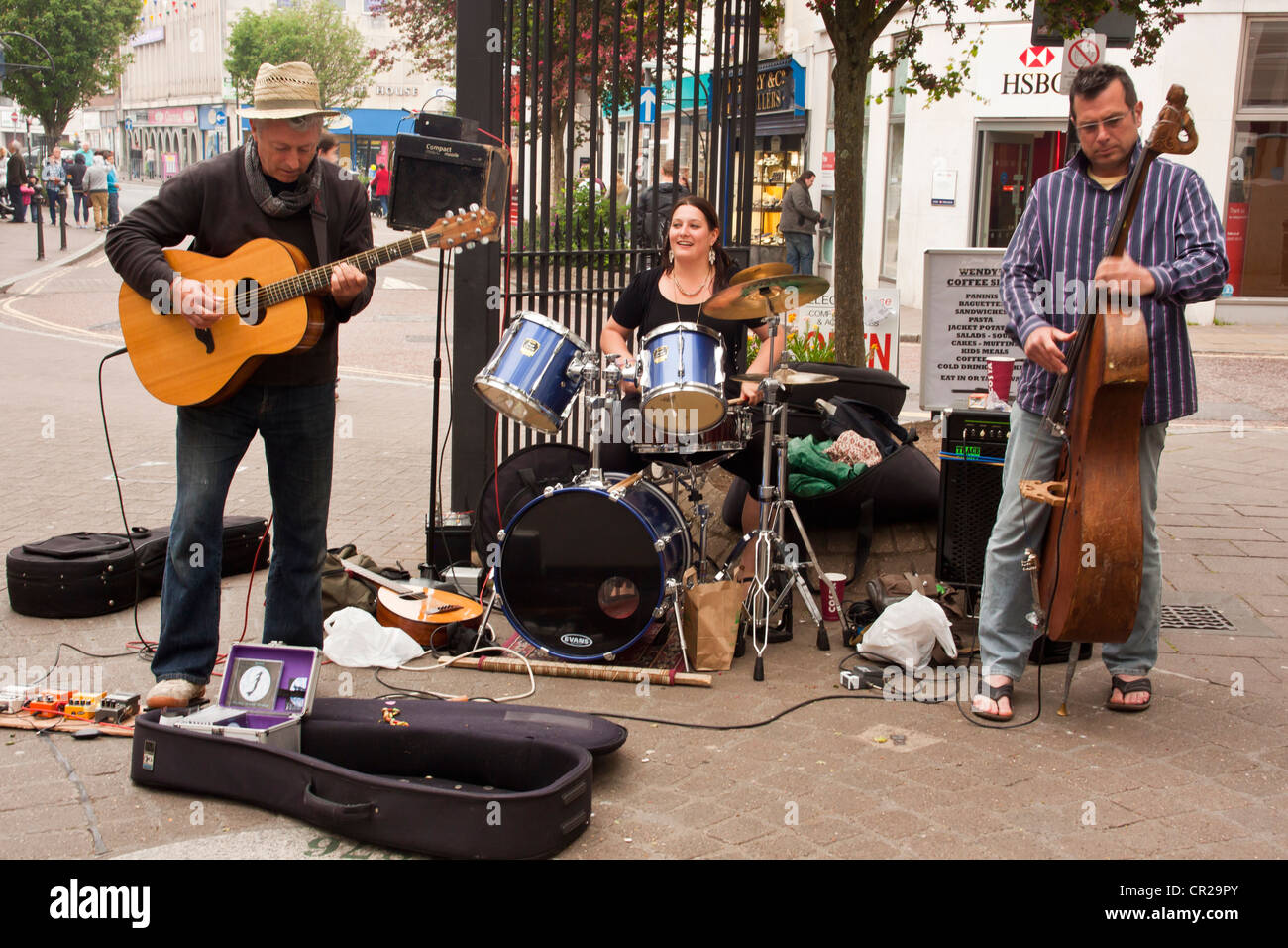 3 piece band, street entertainers busker's busking on the streets of ...