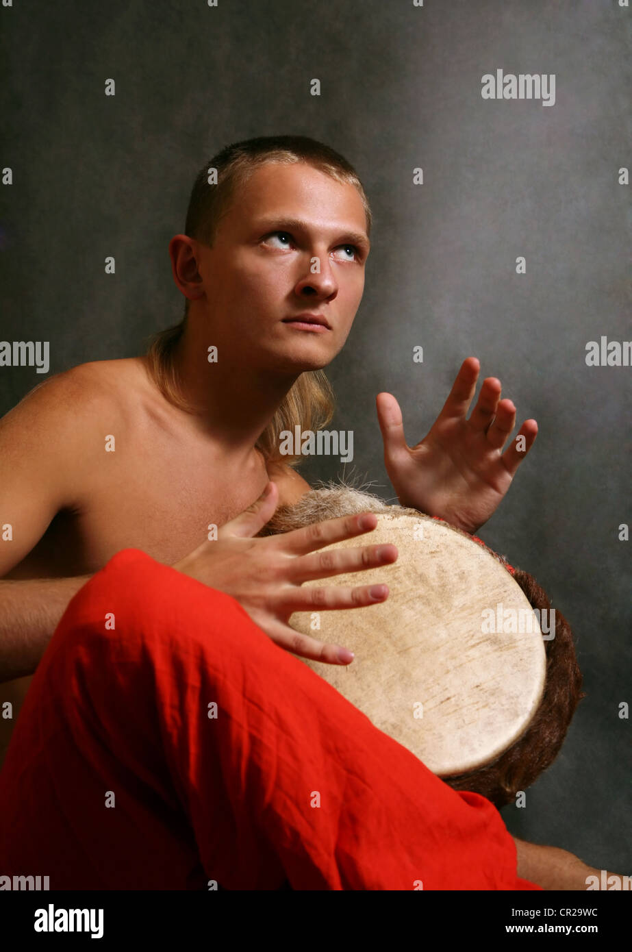 Man playing the nigerian drum in studio Stock Photo - Alamy