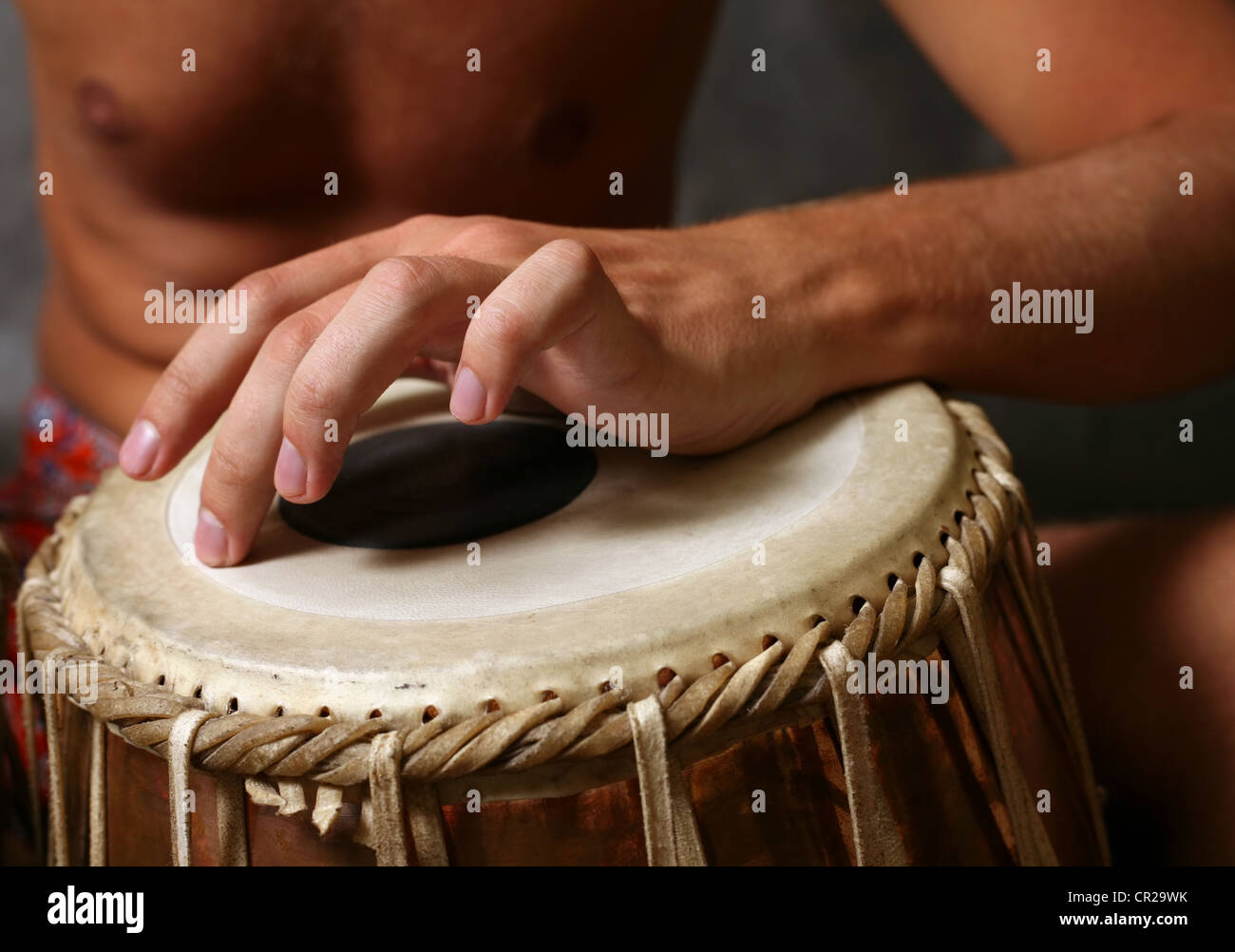 Man playing the djembe (nigerian drum) in studio Stock Photo - Alamy