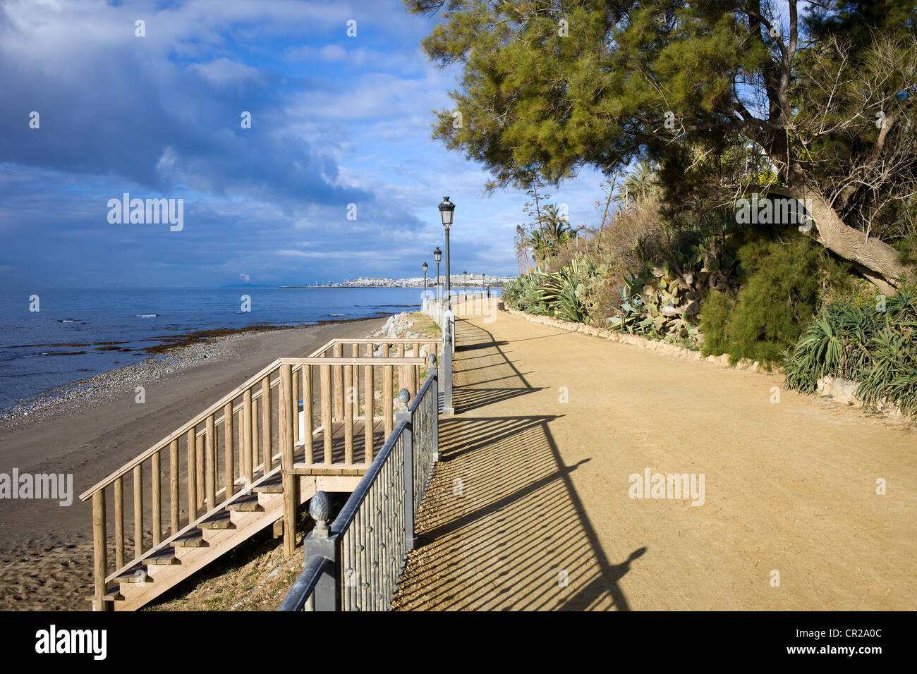 Tranquil footpath with stairs to the beach on Costa del Sol, between ...