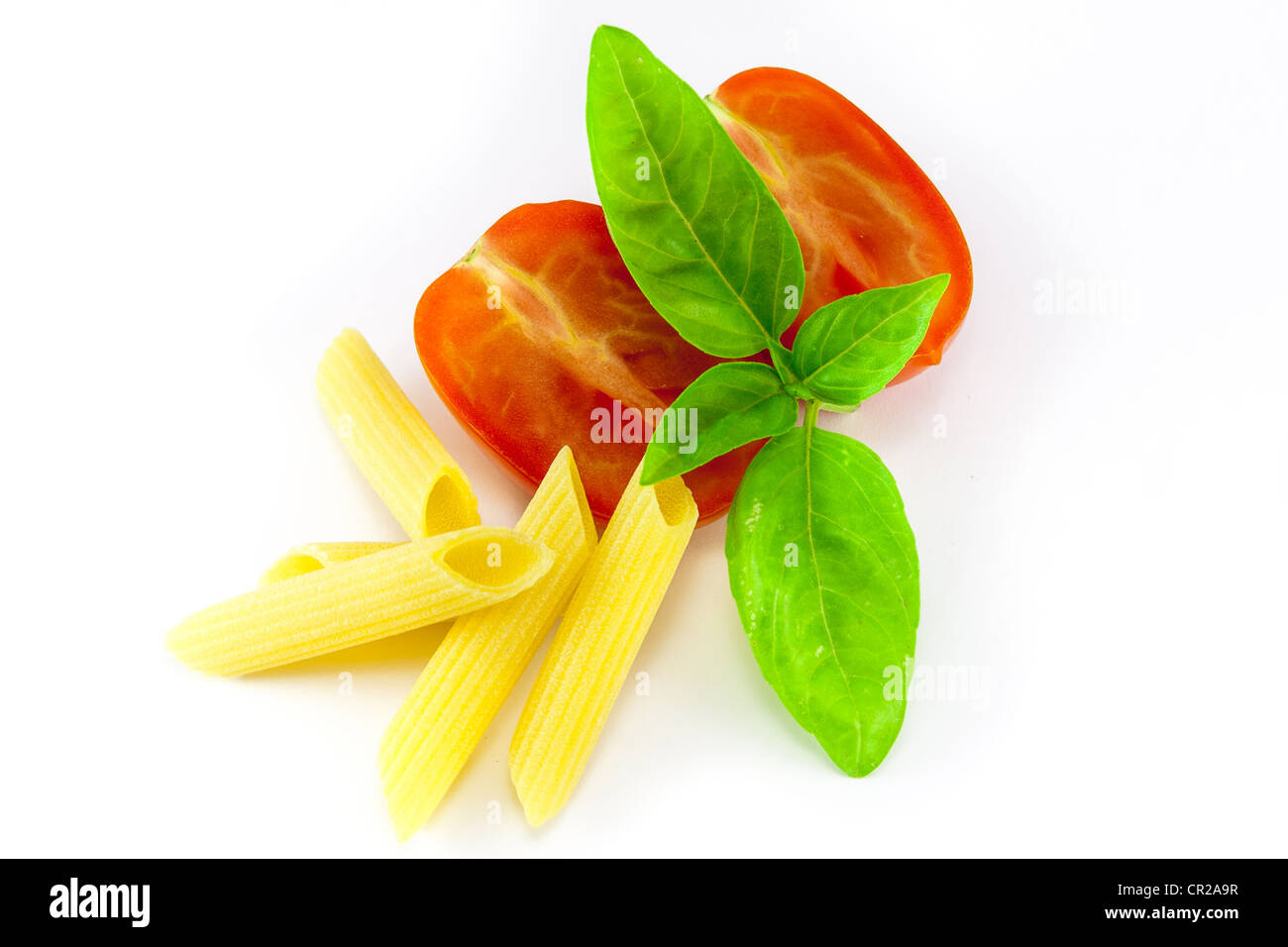 Pens pasta with tomatoes and basil Stock Photo - Alamy