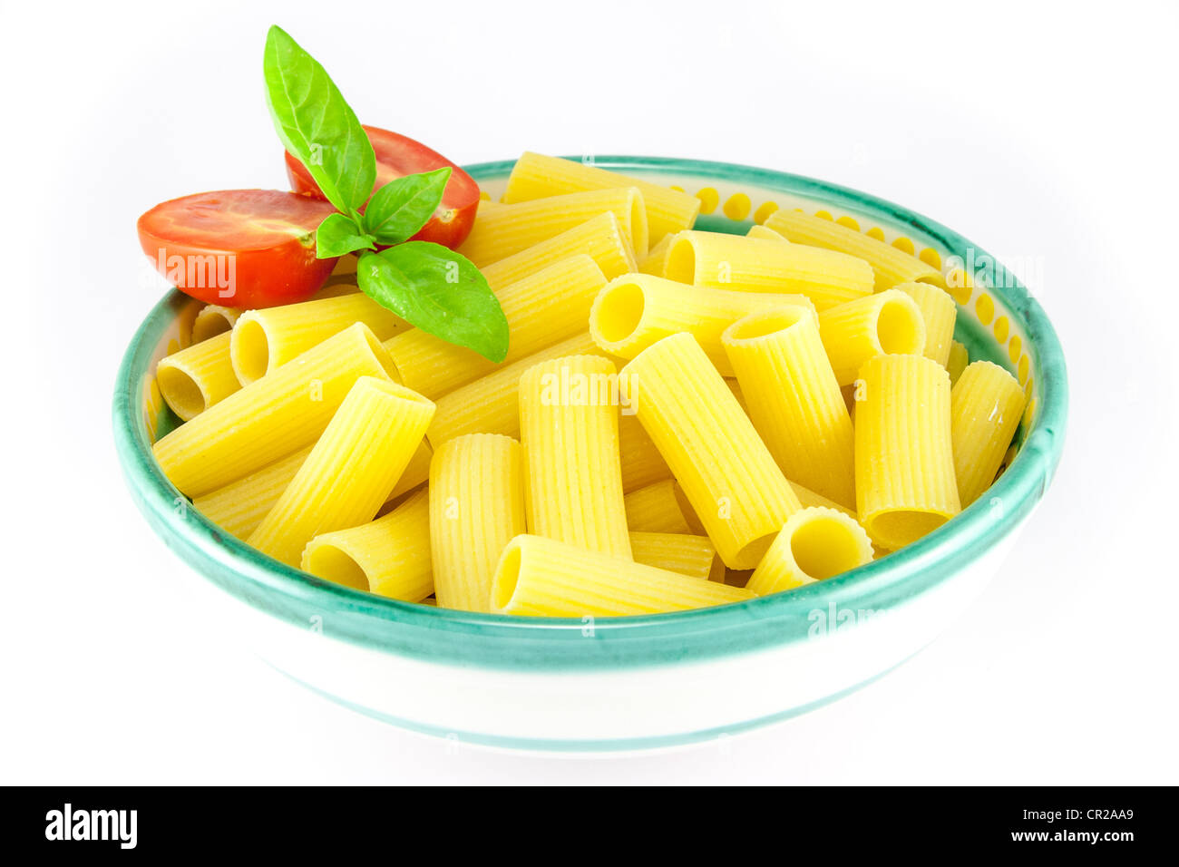 Bowl full of rigatoni pasta with tomatoes and basil Stock Photo - Alamy