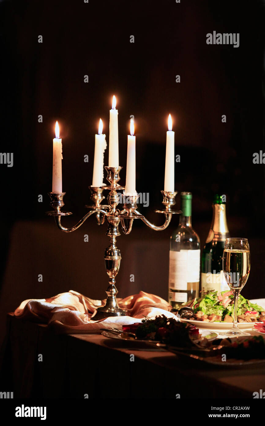 Burning candles in an ancient gold candelabrum Stock Photo - Alamy