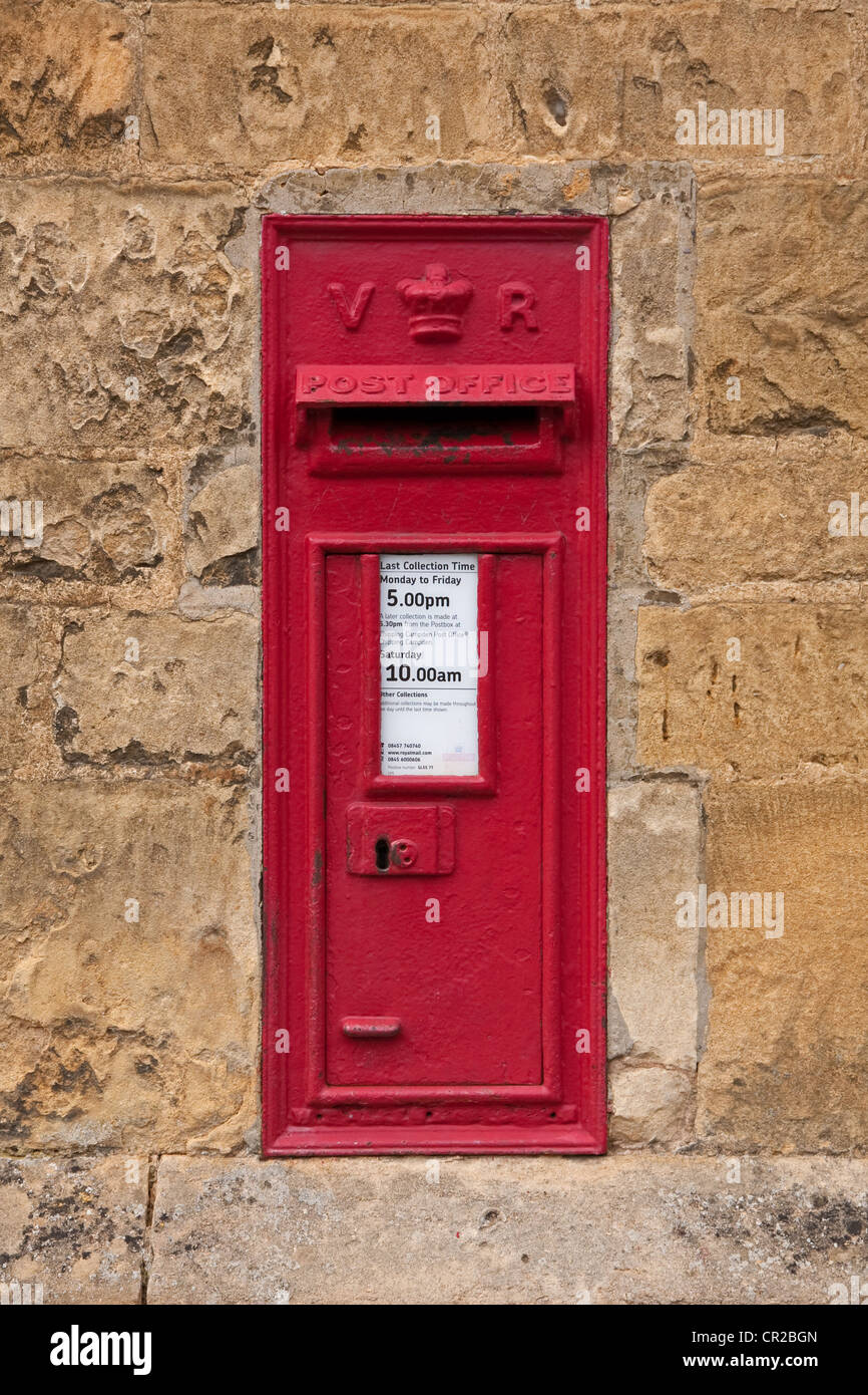 Red VR post box in Cotswold stone wall Stock Photo - Alamy