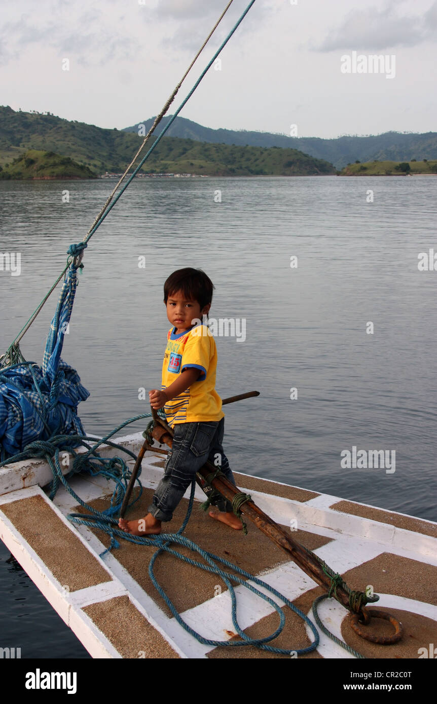 Indonesian Boy on his Fathers Boat Stock Photo - Alamy