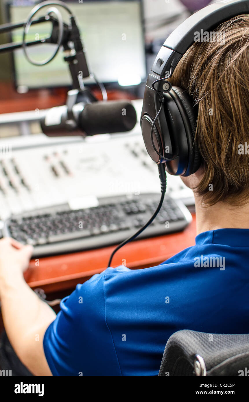 Dj working in front of a microphone on the radio, from the back Stock ...