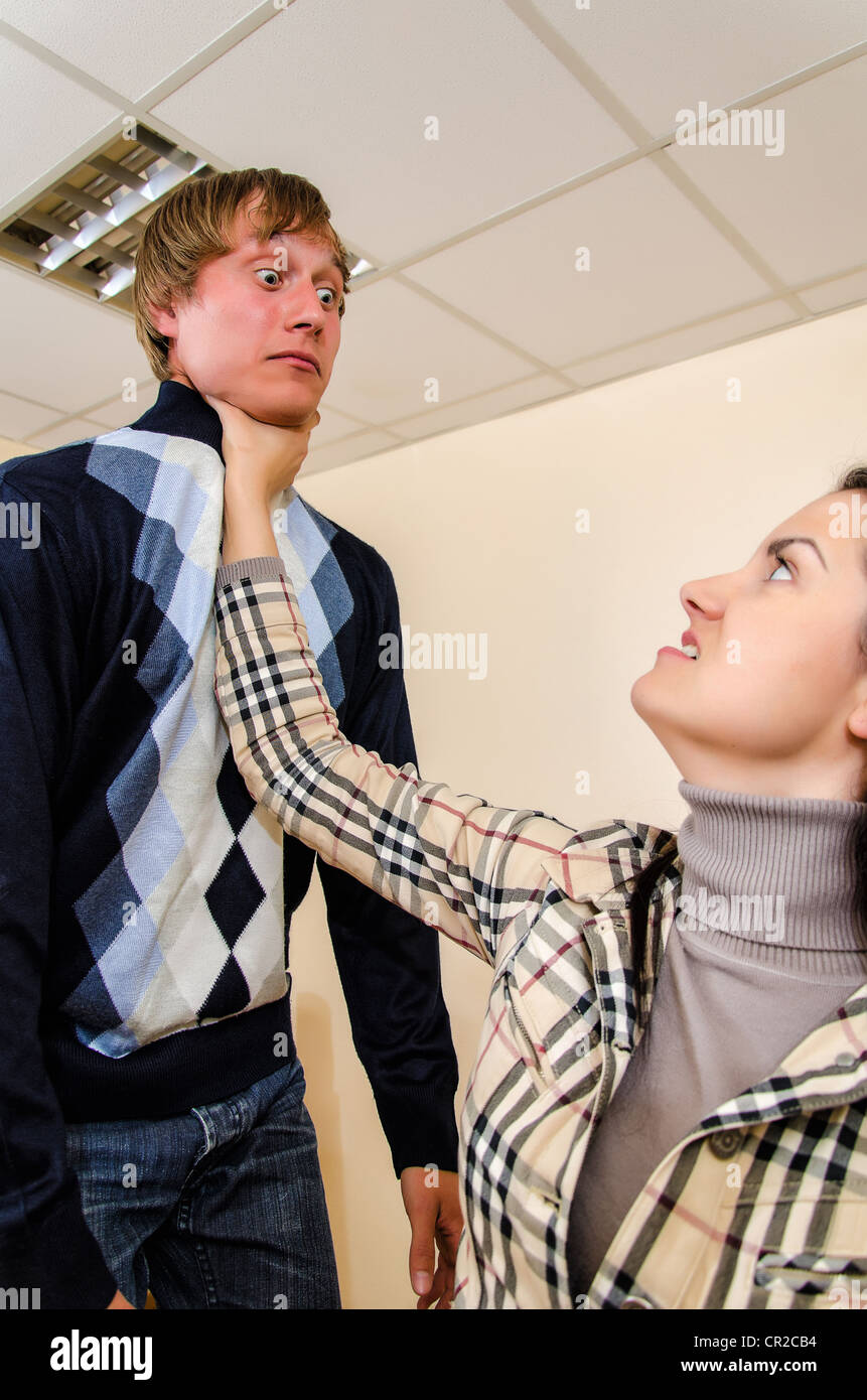 Office fight: Woman trying to stifle a man Stock Photo - Alamy