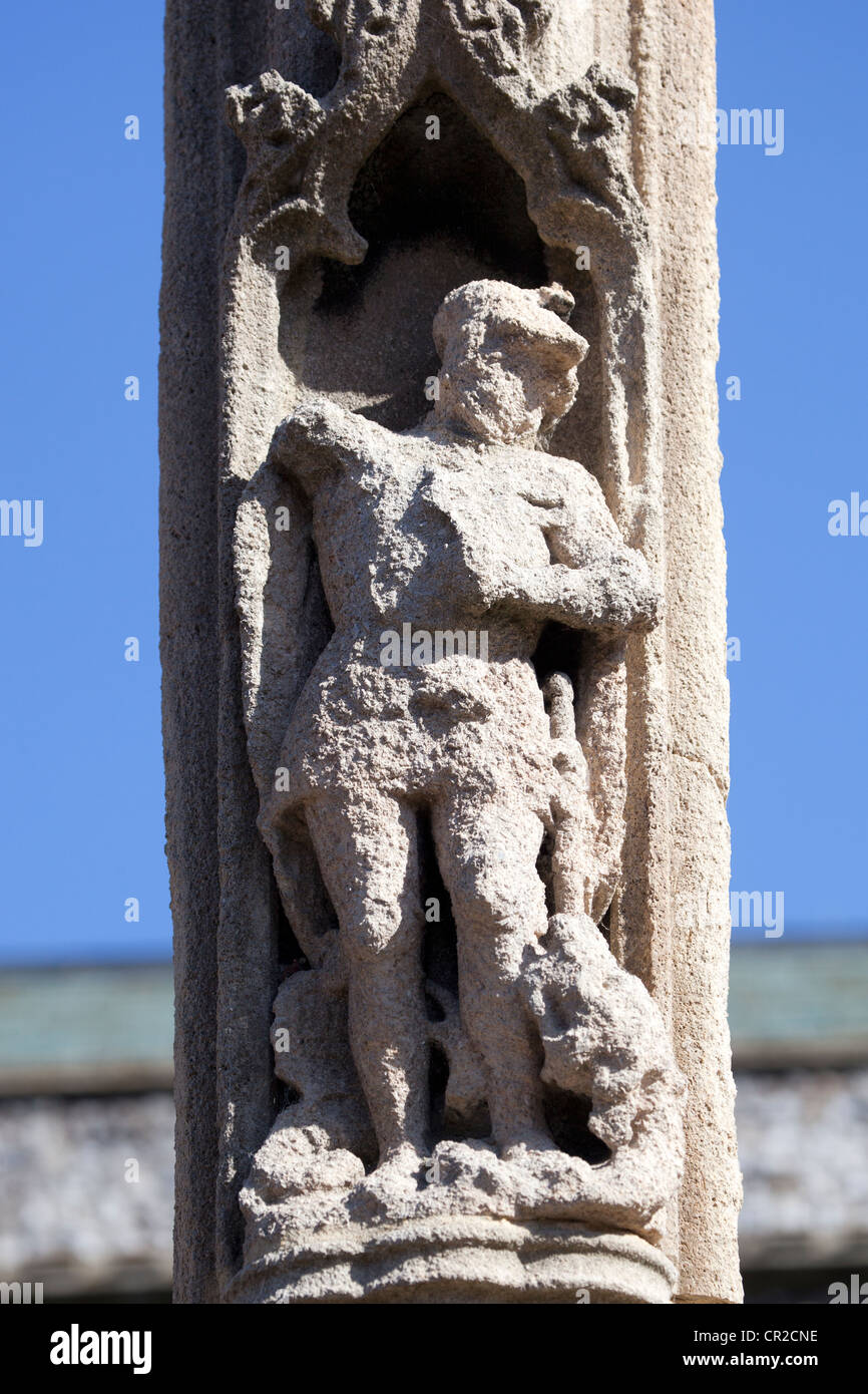 Stone Figure on Cross in the grounds of St Peter and Paul Church Stock ...