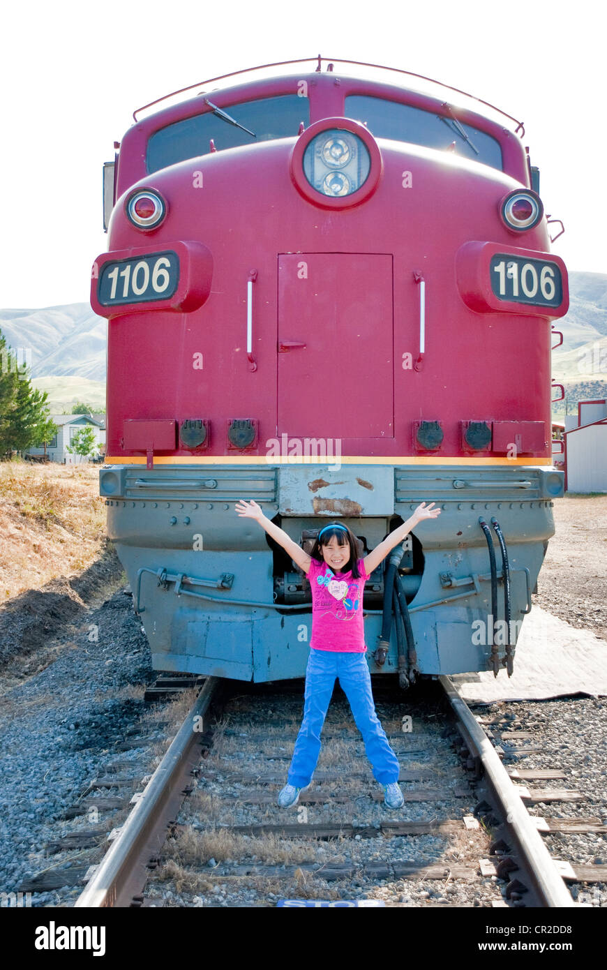 Jumping for joy, this little Asian girl is excited to board the train ...