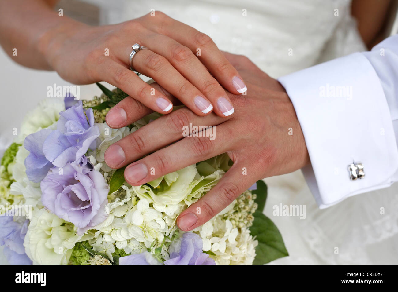 Hand of the groom and the bride with wedding bouquet Stock Photo - Alamy