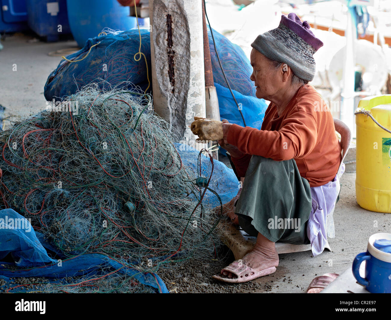 Elderly Asian woman working with fishing nets at Hua Hin Thailand Stock ...