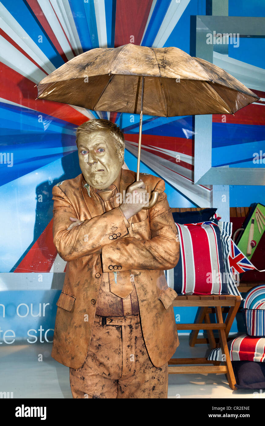 The Gold Man living human street Statue. Comical Andy Train in golden ...