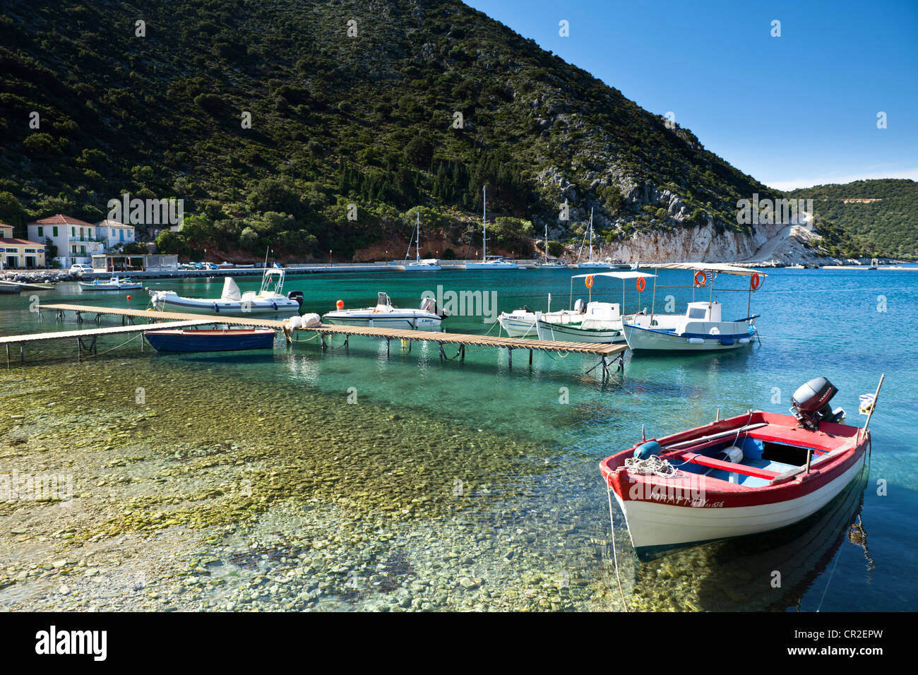 Fishing boats and yachts moored in the harbour at Frikes on the island ...