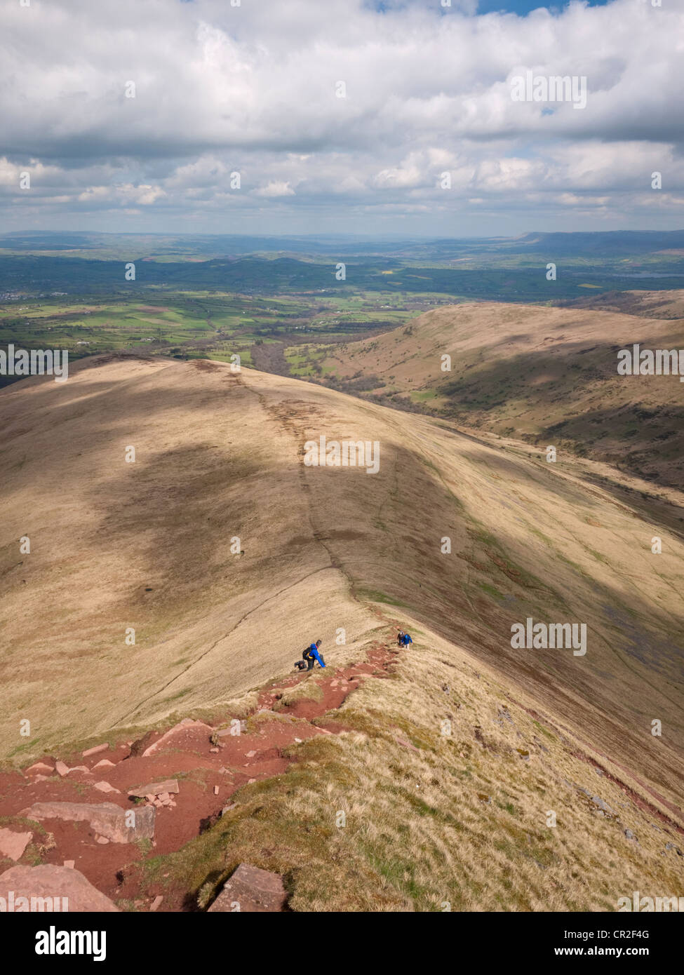 Walkers clamber up the steep ridge of Bryn Teg, towards the summit of ...