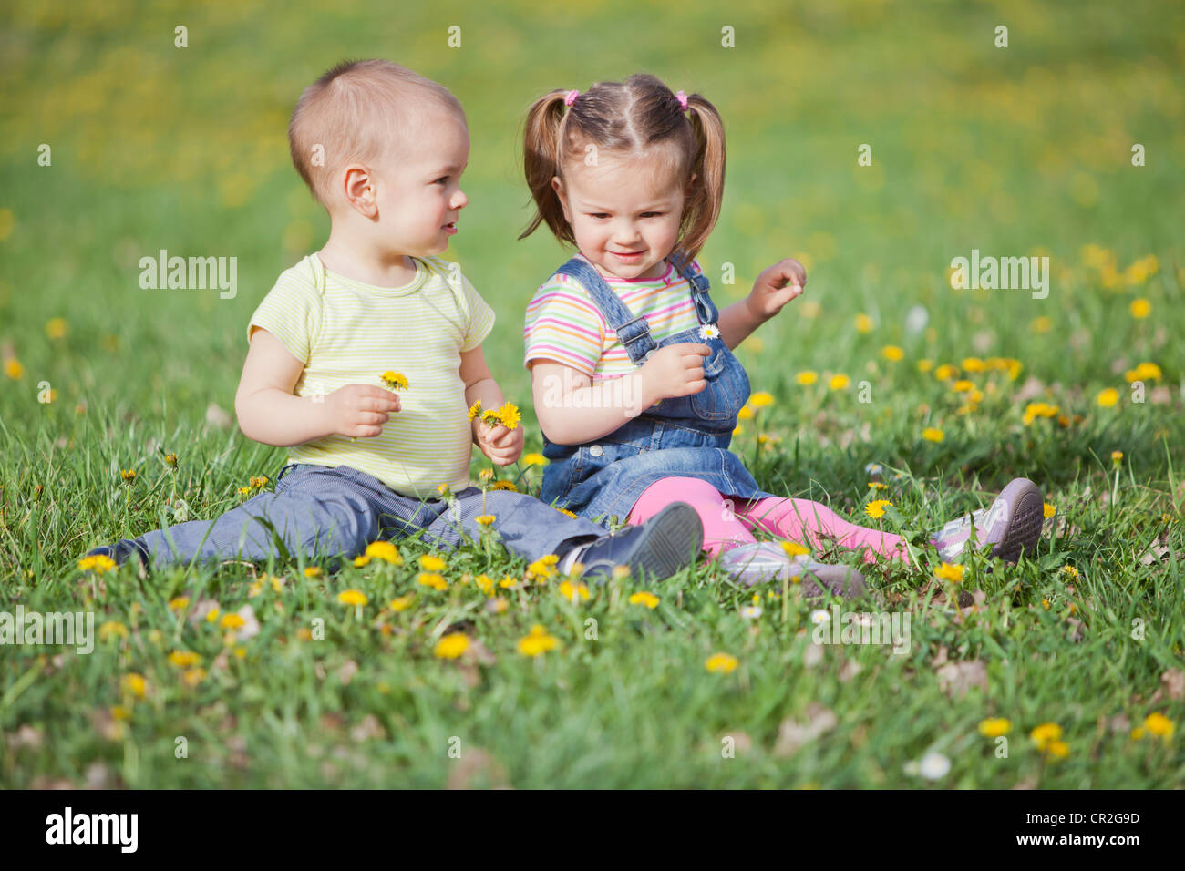 Two kids in the field Stock Photo - Alamy