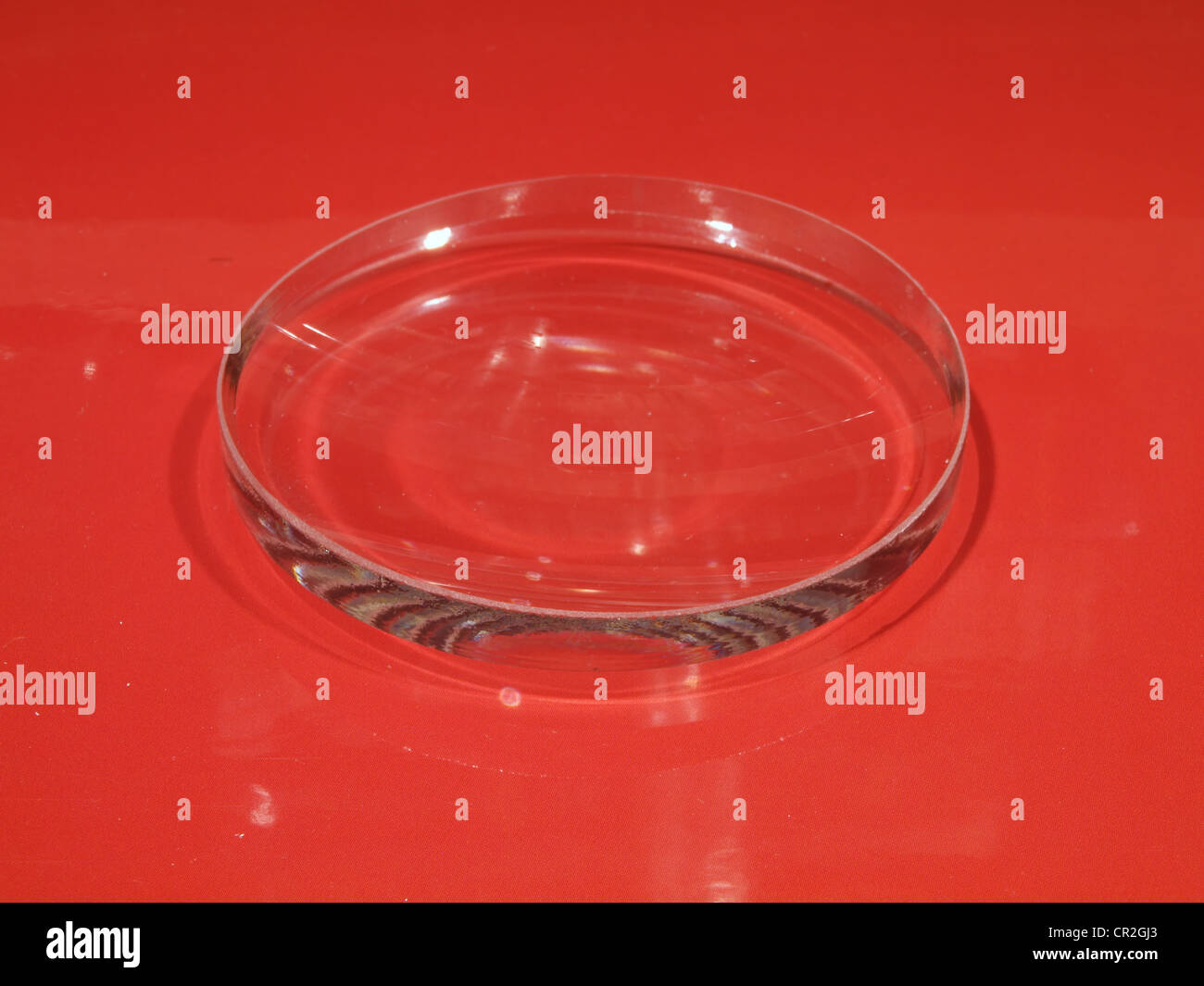Glass lens on a red background Stock Photo - Alamy