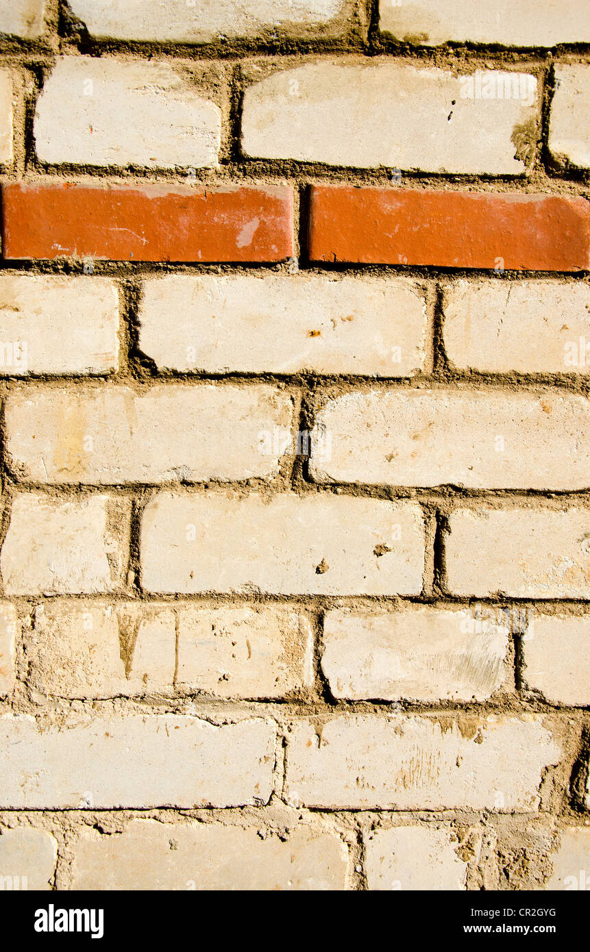 Background of white brick wall and one horizontal row of red brick ...