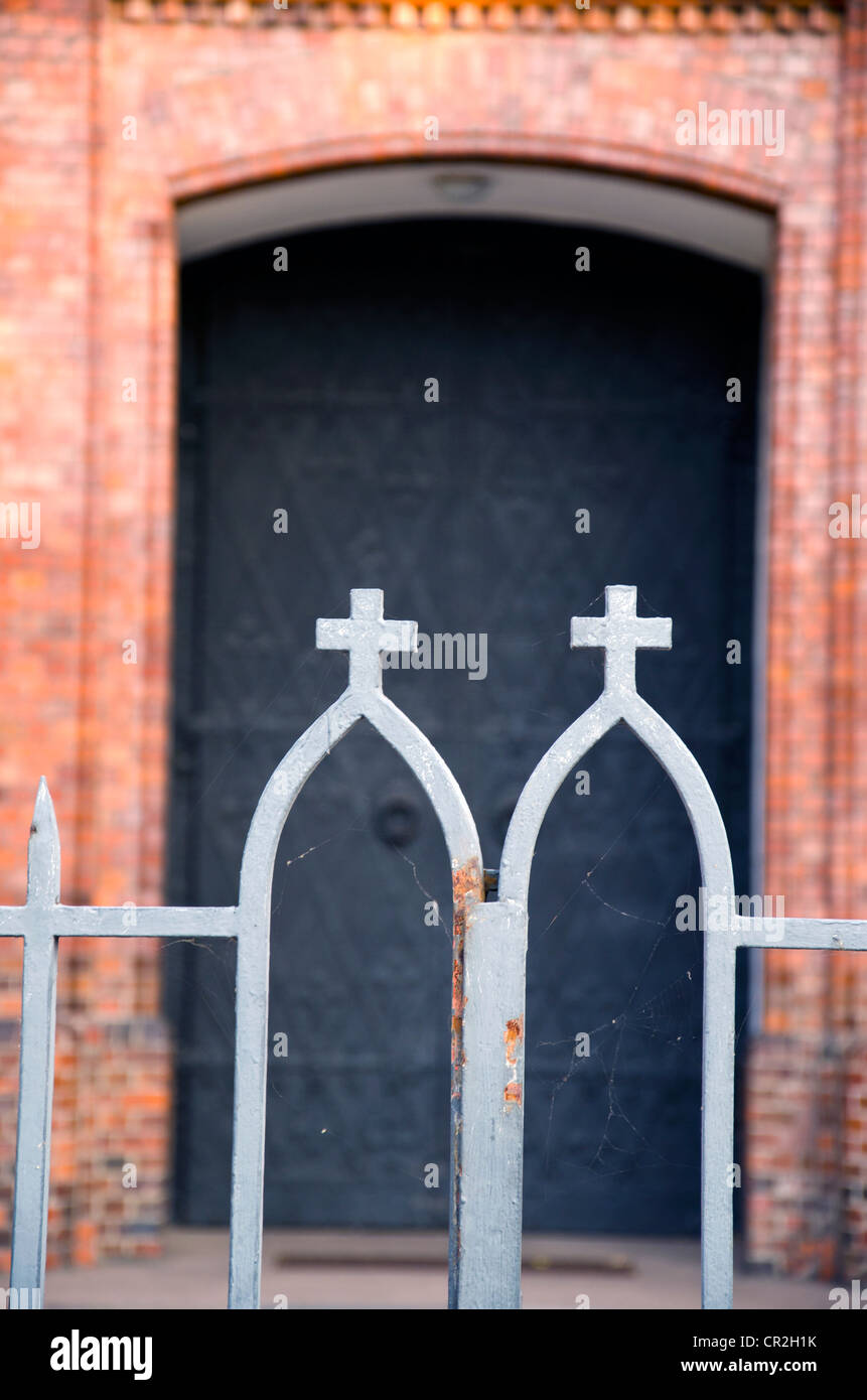 church steel gate and fragment of entrance. religious symbol cross and ...