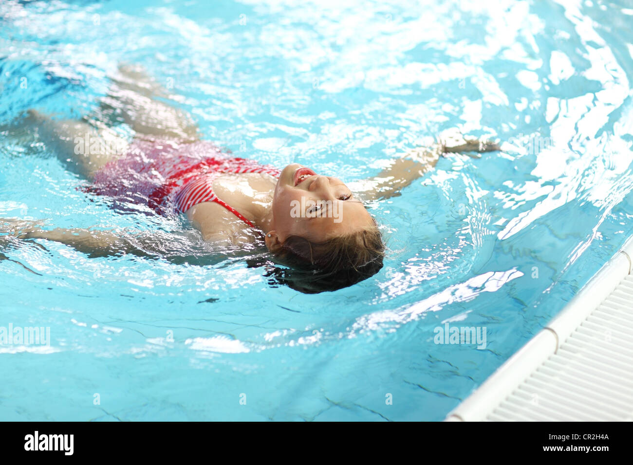 Child swimming backstroke in the pool Stock Photo - Alamy