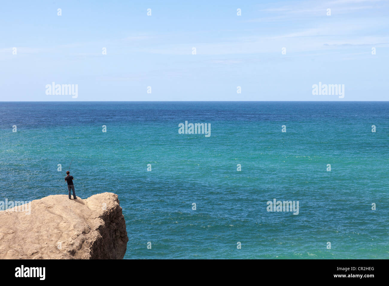 People fishing on a cliff at Castlepoint, Wairarapa coast, Wellington ...