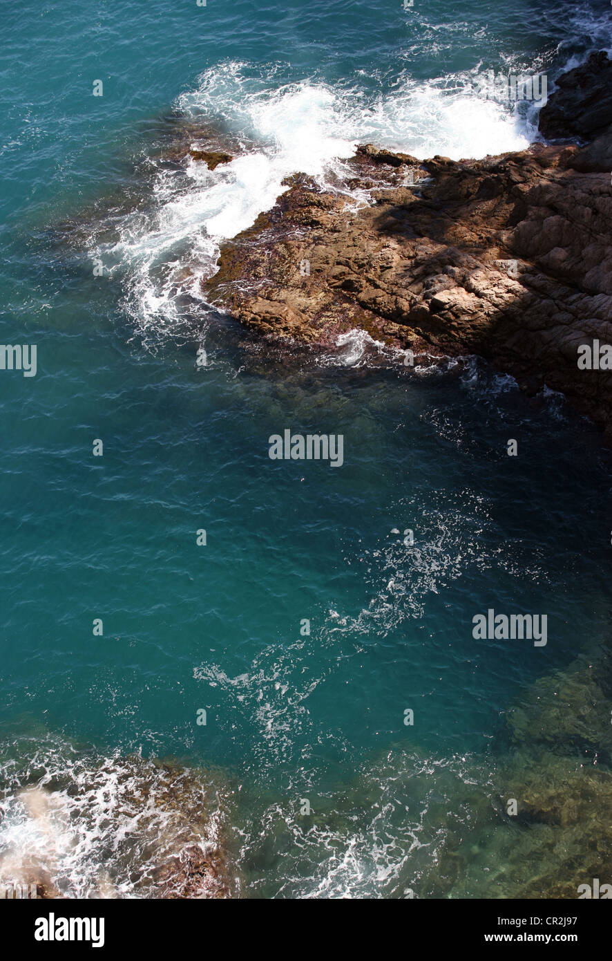 The dark blue both transparent sea and high rocks Stock Photo - Alamy