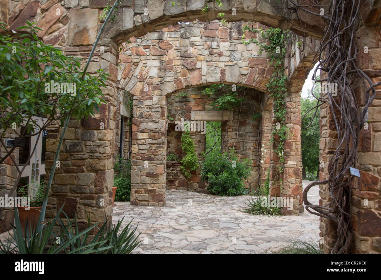 Stone arches covered in vines at the Ladybird Johnson wildflower center ...