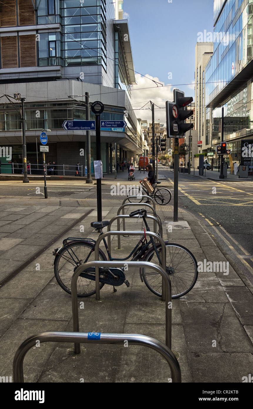 Bicycles in bicycle stands Moseley street Manchester Stock Photo - Alamy