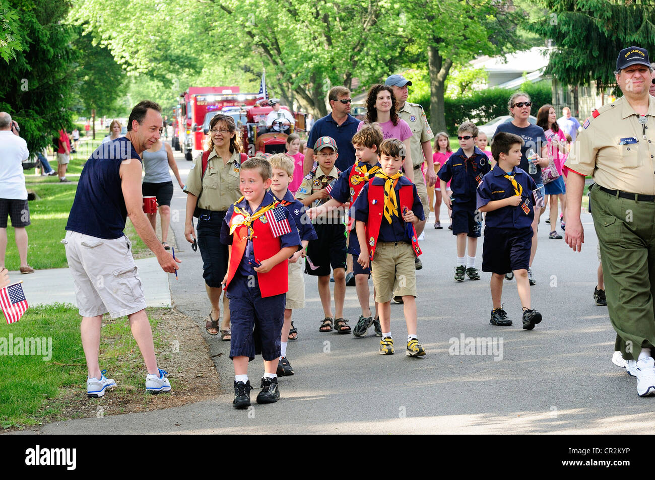 Boy Scout troop handing out pencils during Memorial Day Parade in small ...